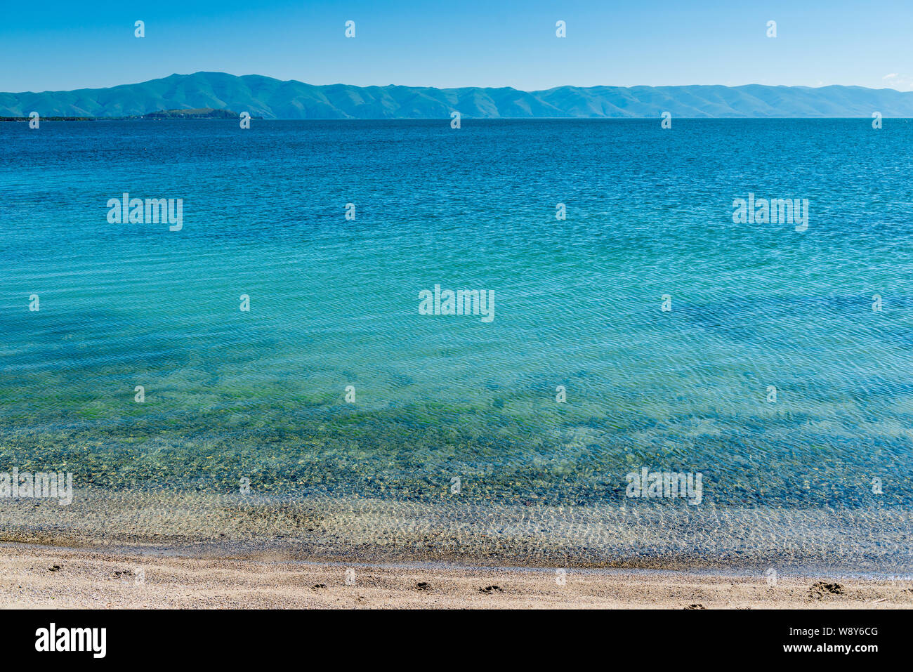 The water surface of Lake Sevan with a beautiful view of the mountains ...