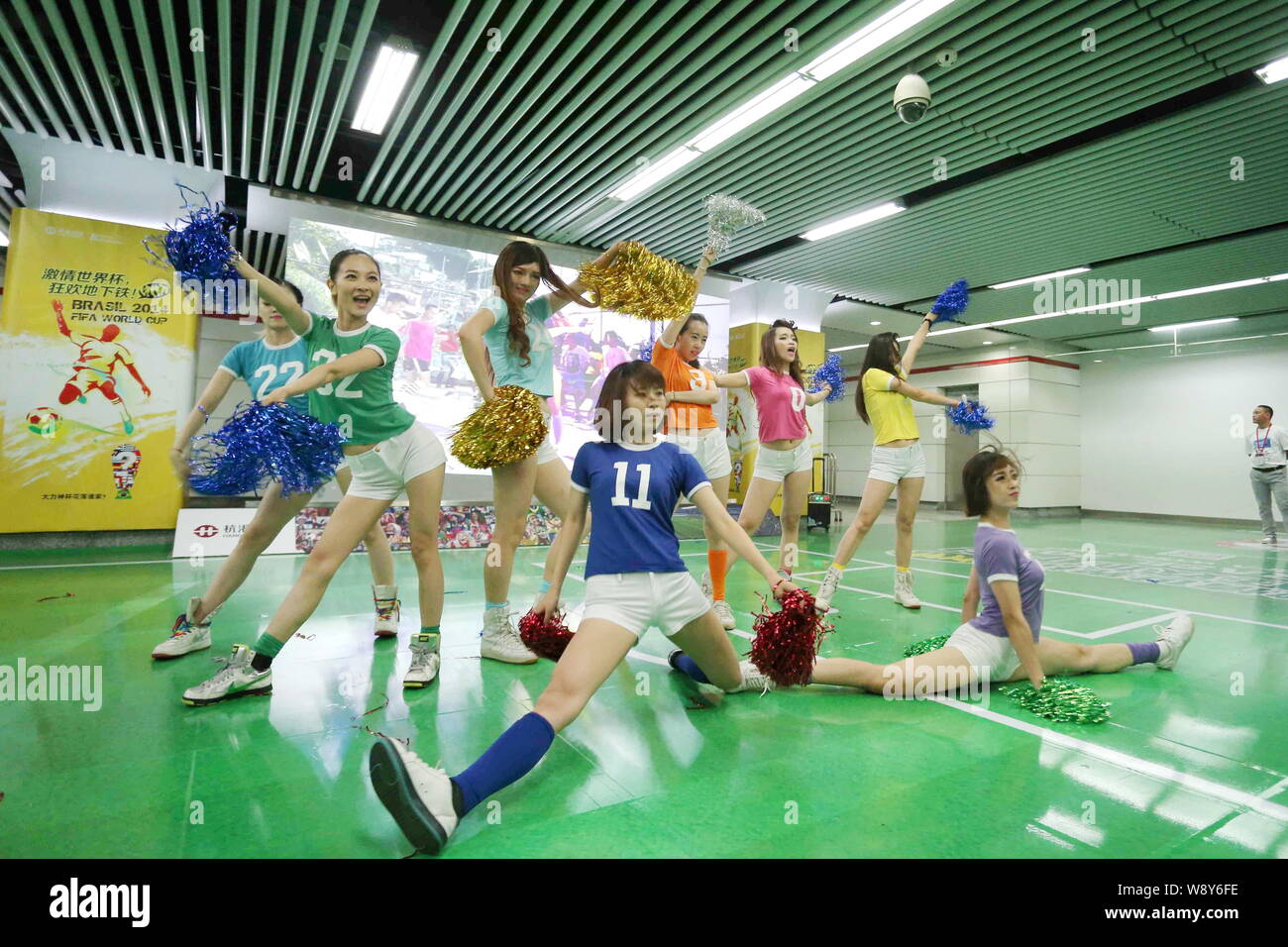 Young Chinese cheerleaders dance to celebrate the upcoming 2014 FIFA ...