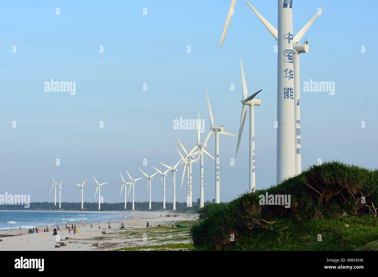--FILE--Wind turbines whirl to generate electricity at an offshore wind ...