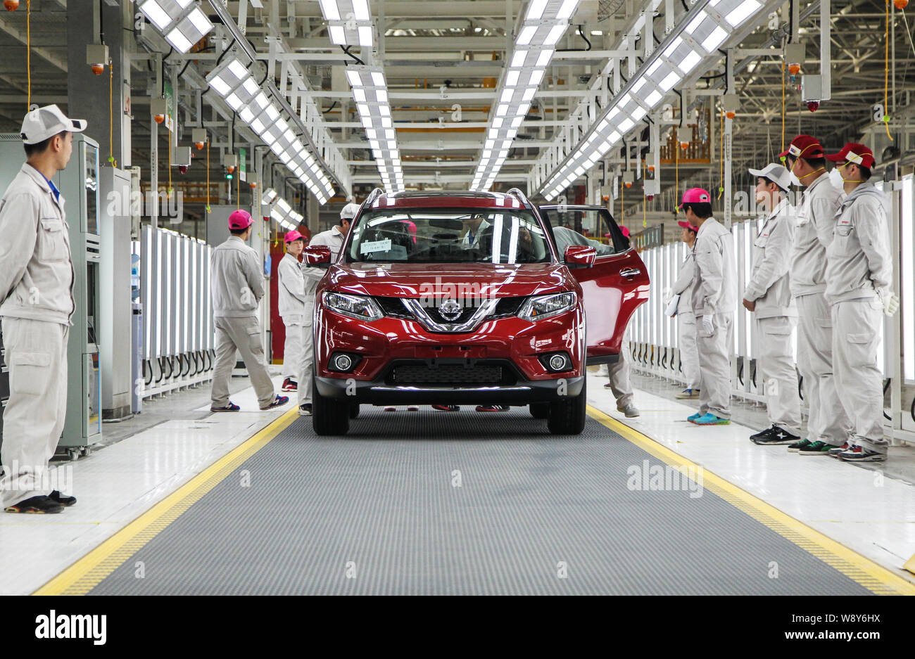 --FILE--Chinese workers assemble a car on the assembly line at the auto ...