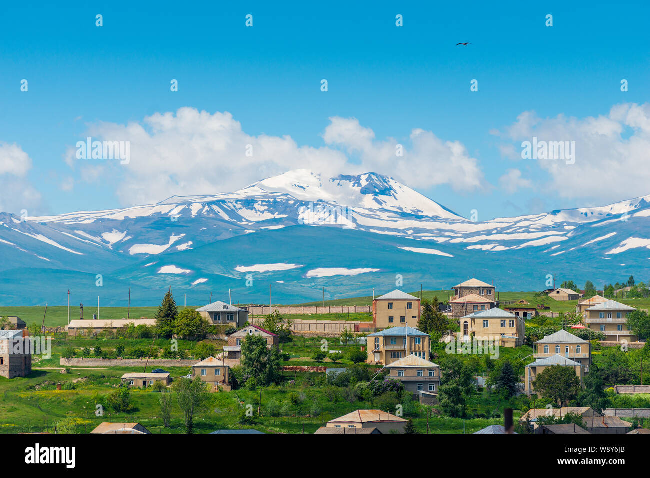 Armenian mountain with a snowy peak and a view of the Armenian village ...