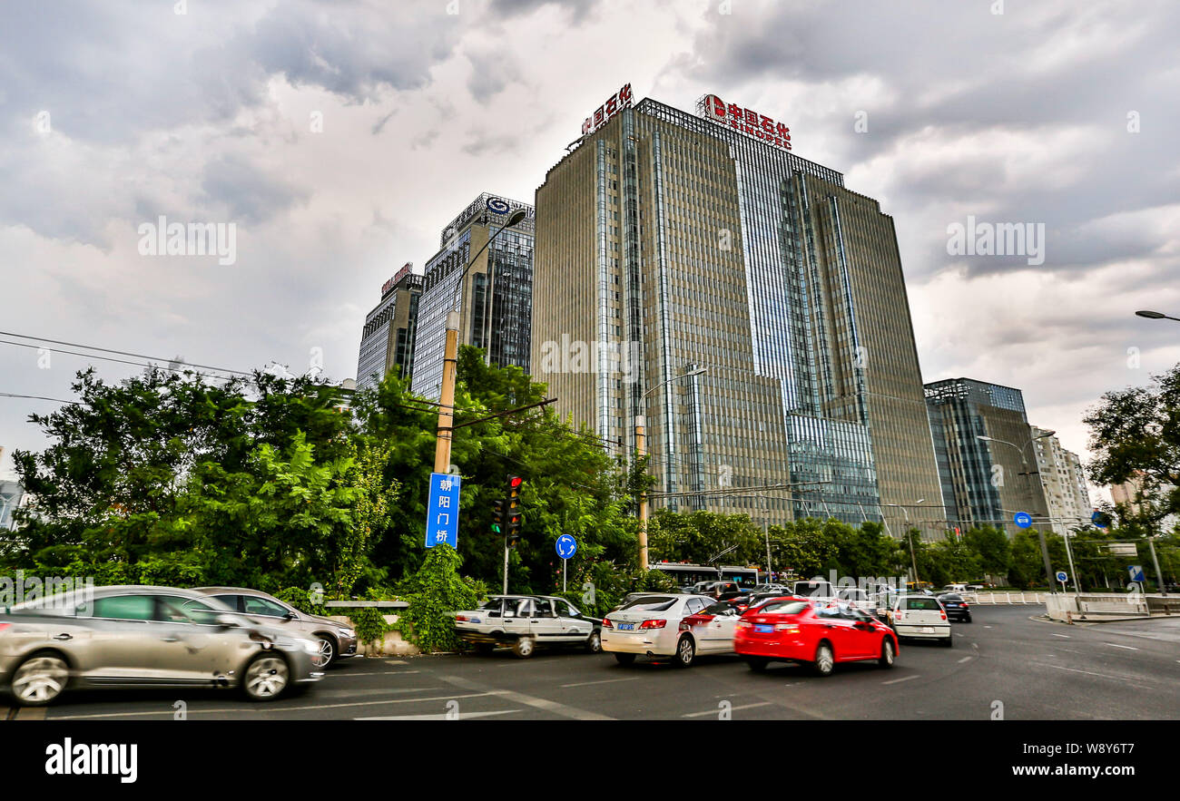 --FILE--Vehicles drive past the headquarters building of Sinopec in ...