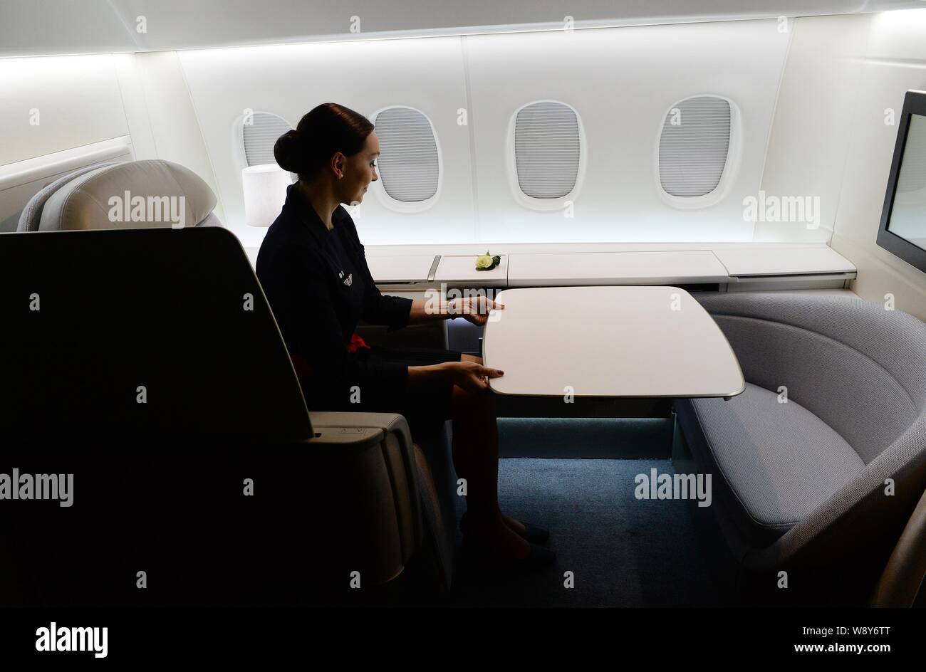 An airhostess of Air France unfolds a table at the new first-class ...