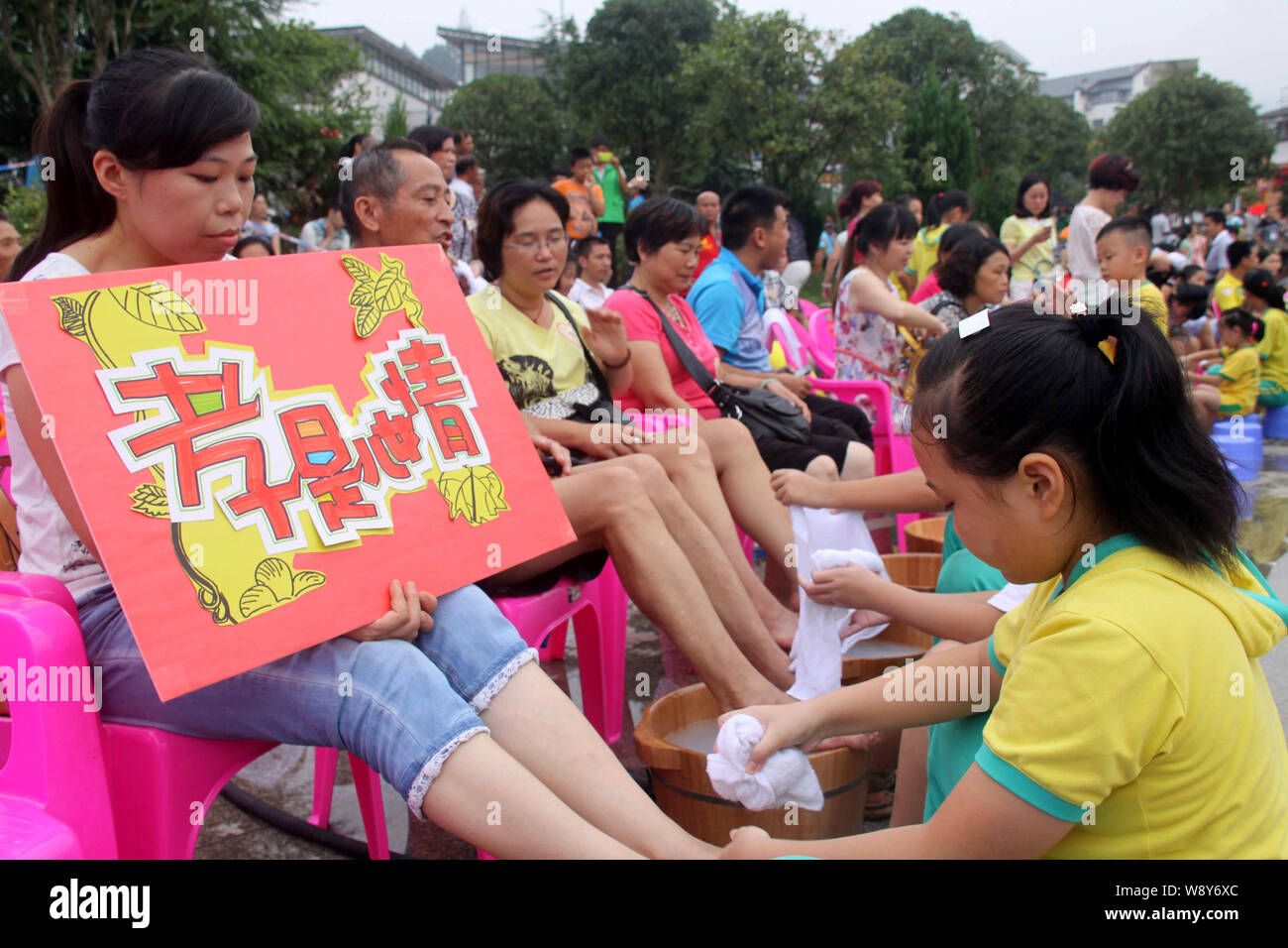 Young kids are washing their parents' feet during a foot-washing ...