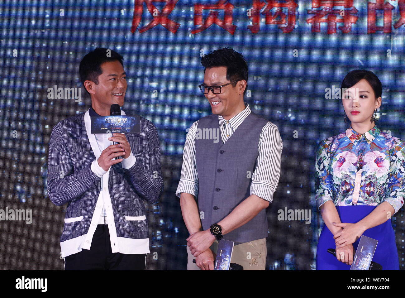 Hong Kong actors Louis Koo, left, and Gordon Lam Ka-tung, center, smile ...