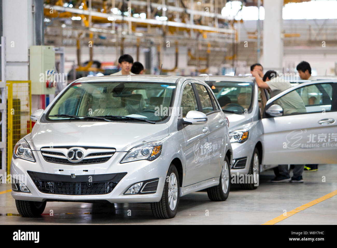 --FILE--Chinese workers assemble E150 electric vehicles on the assembly ...