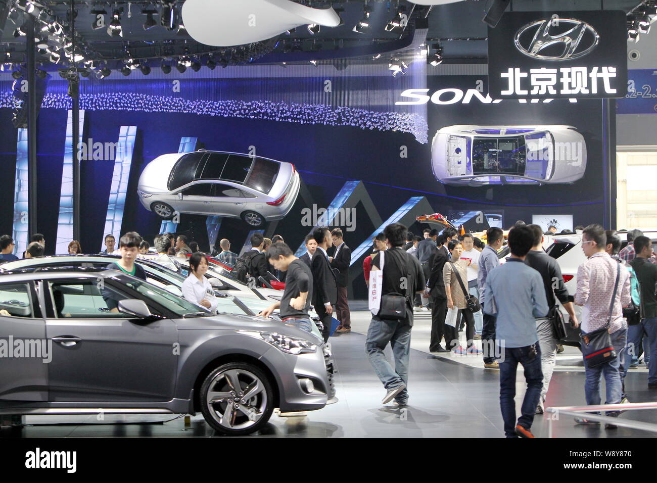 --FILE--Visitors look at cars of Beijing Hyundai, a joint venture ...