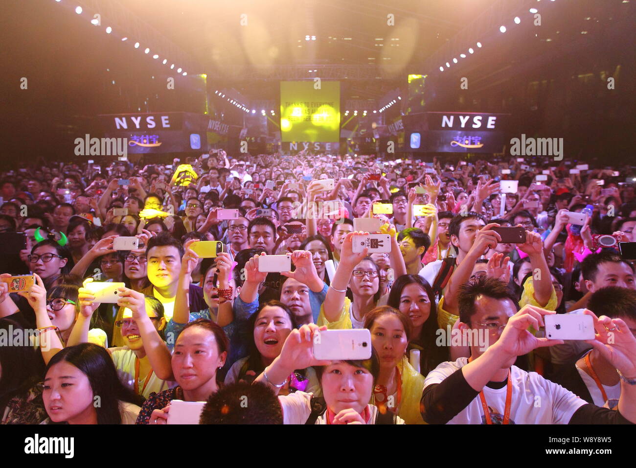 Chinese employees of Alibaba Group take photos to celebrate Alibaba's ...