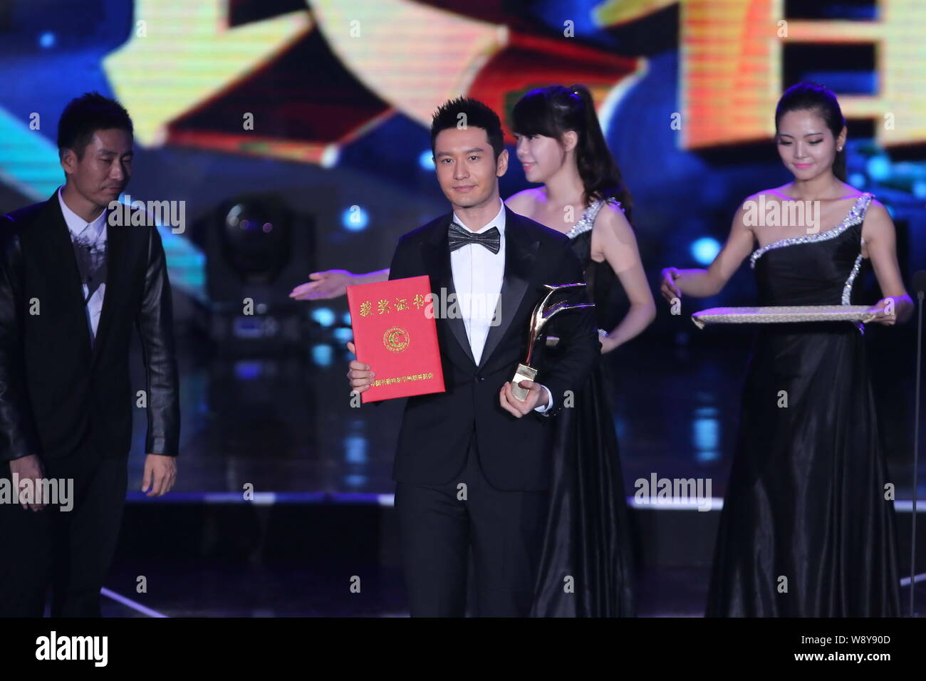 Chinese actor Huang Xiaoming poses with his "Best Actor" trophy during ...