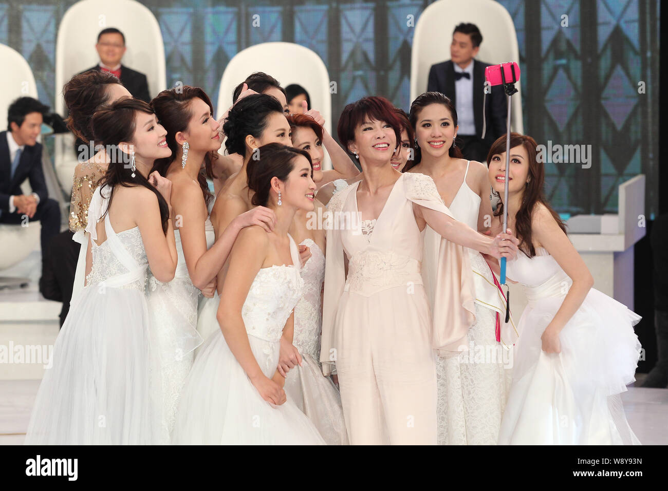Hong Kong host Carol Cheng, center, takes a selfie with the Top 10 ...