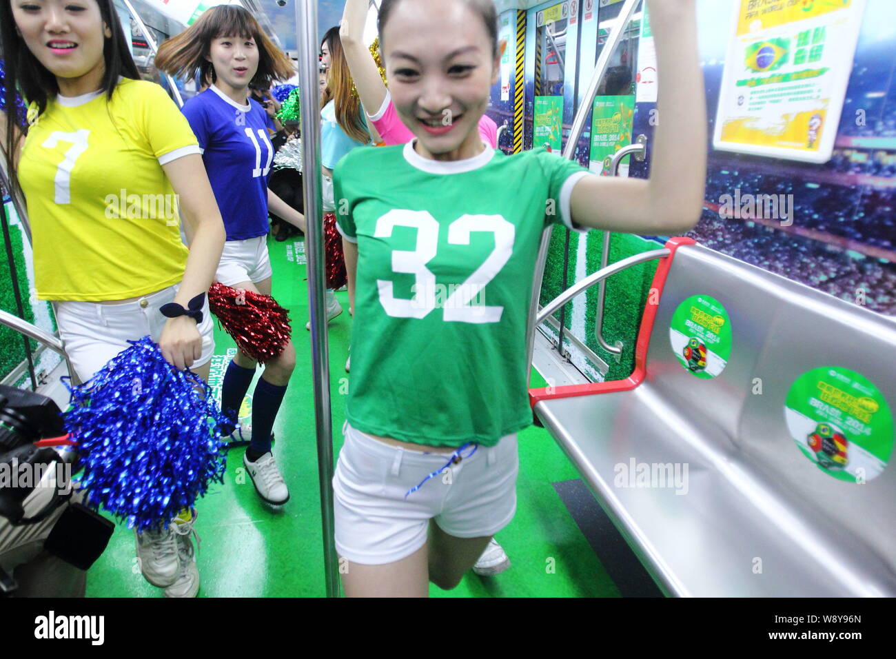 Young Chinese cheerleaders dance aboard the special train of Hangzhou ...