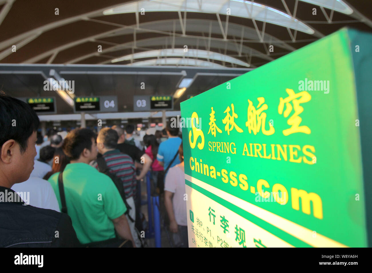 --FILE--Passengers queue up to get boarding passes at the counters of ...