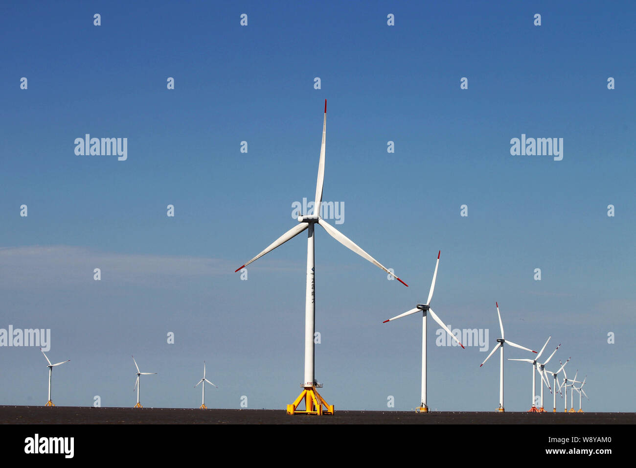 --FILE--Wind turbines whirl to generate electricity at an offshore wind ...