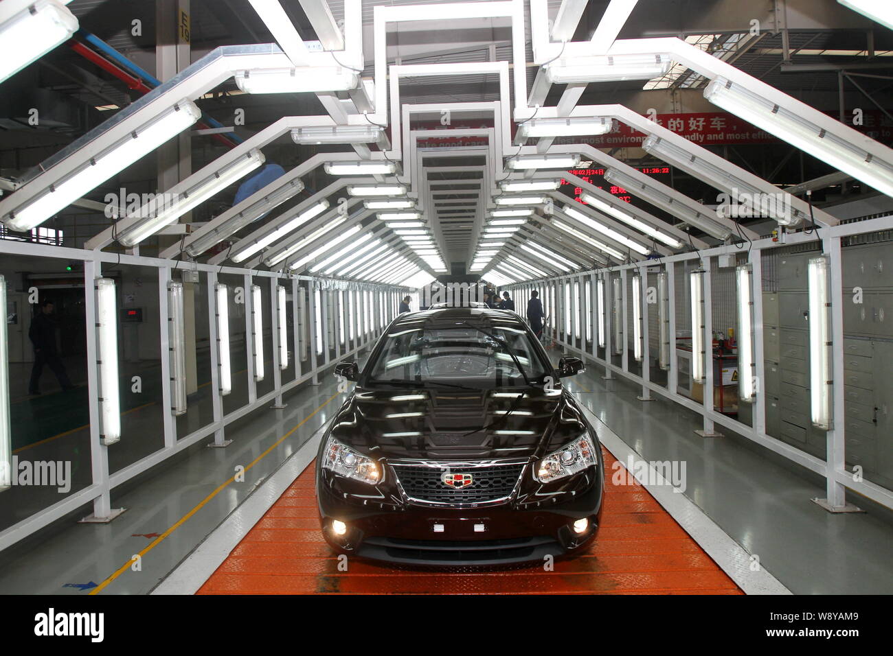 --FILE--Chinese workers assemble Geely cars on an assembly line at a ...