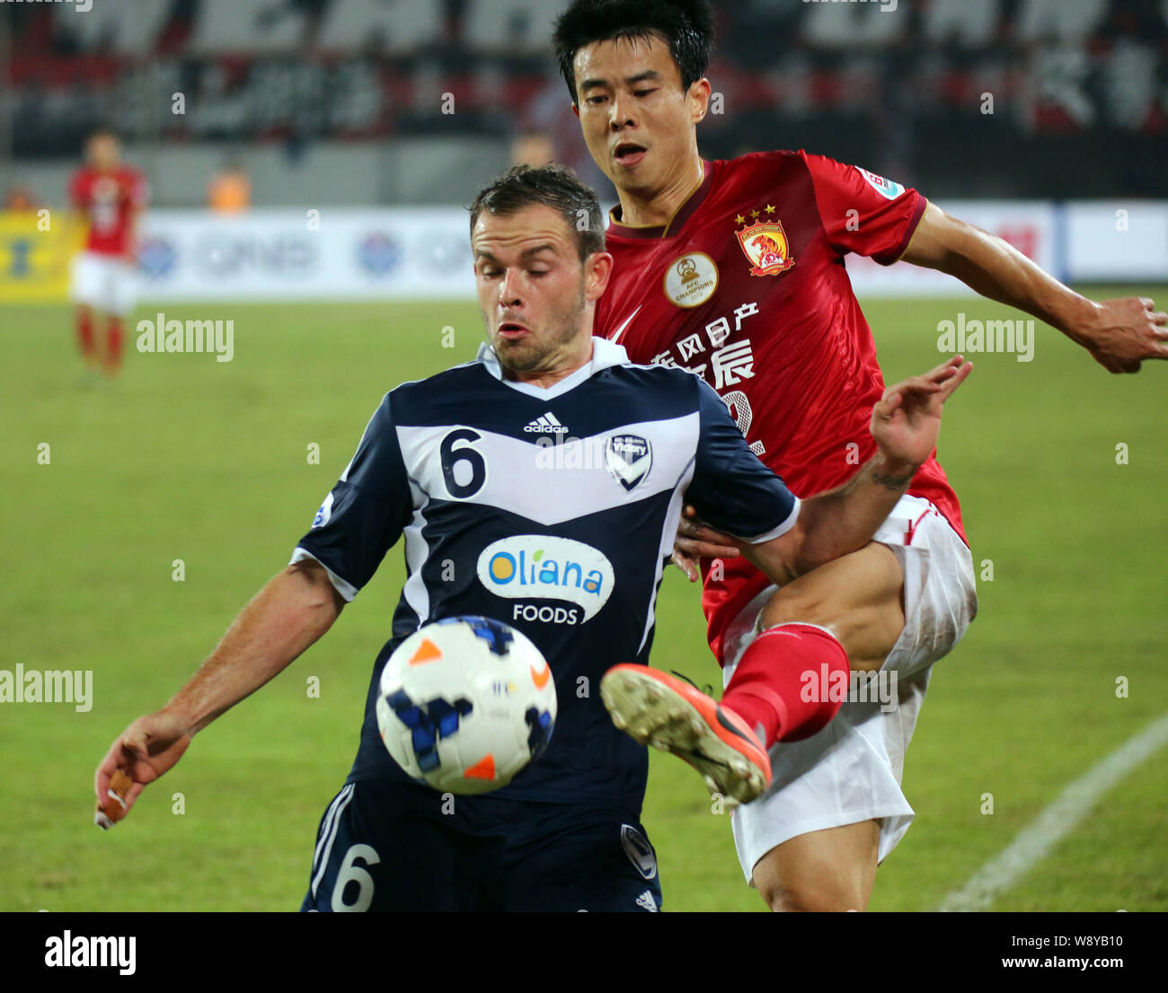 Sun Xiang of Chinas Guangzhou Evergrande, back, challenges Leigh ...
