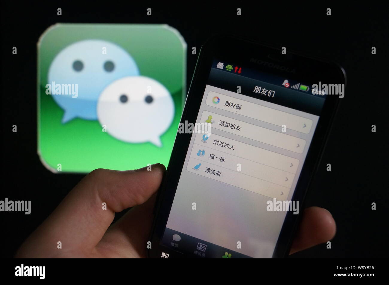 --FILE--A Chinese mobile phone user uses the messaging app Weixin, or WeChat, of Tencent on ...