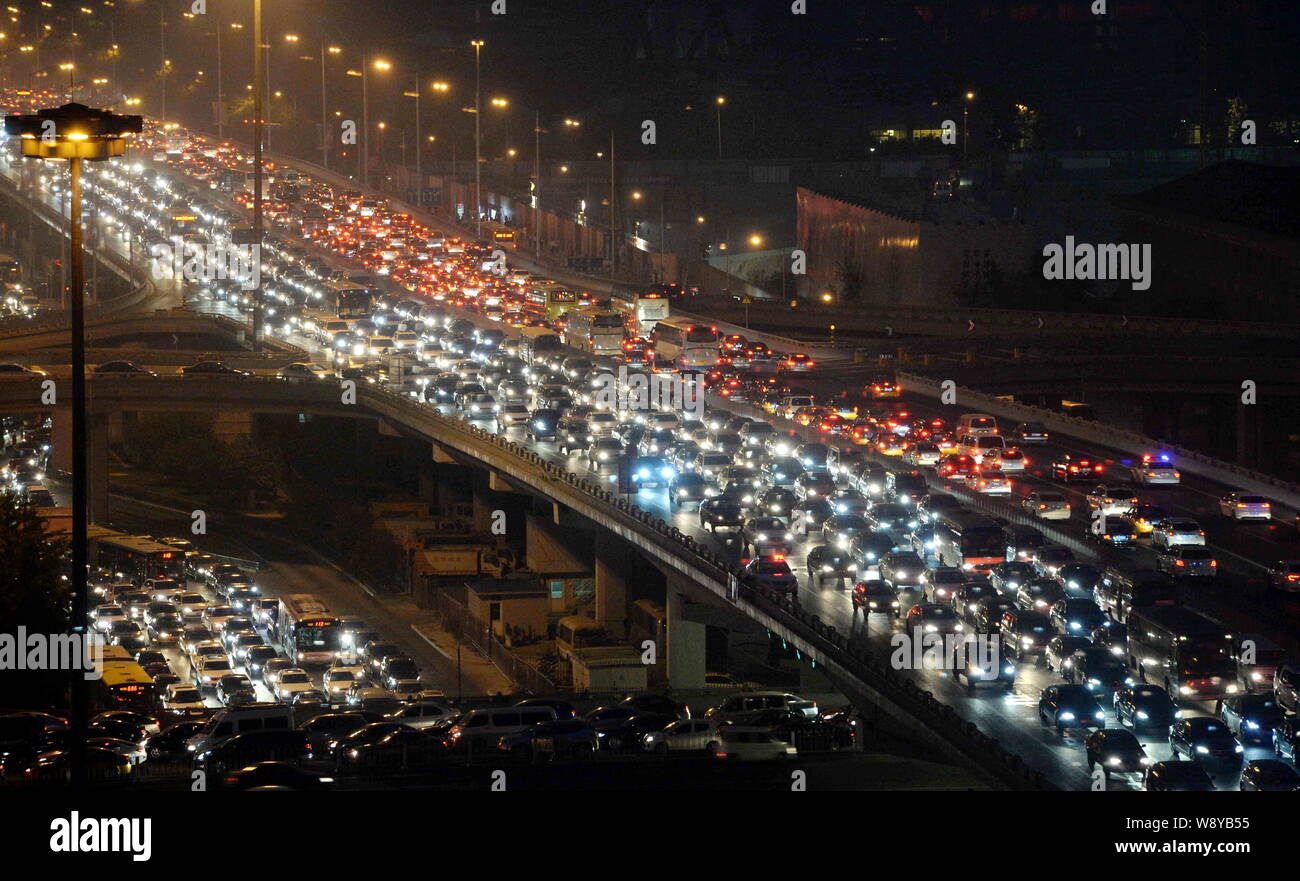 Night view of highways and roads overcrowded by masses of vehicles ...