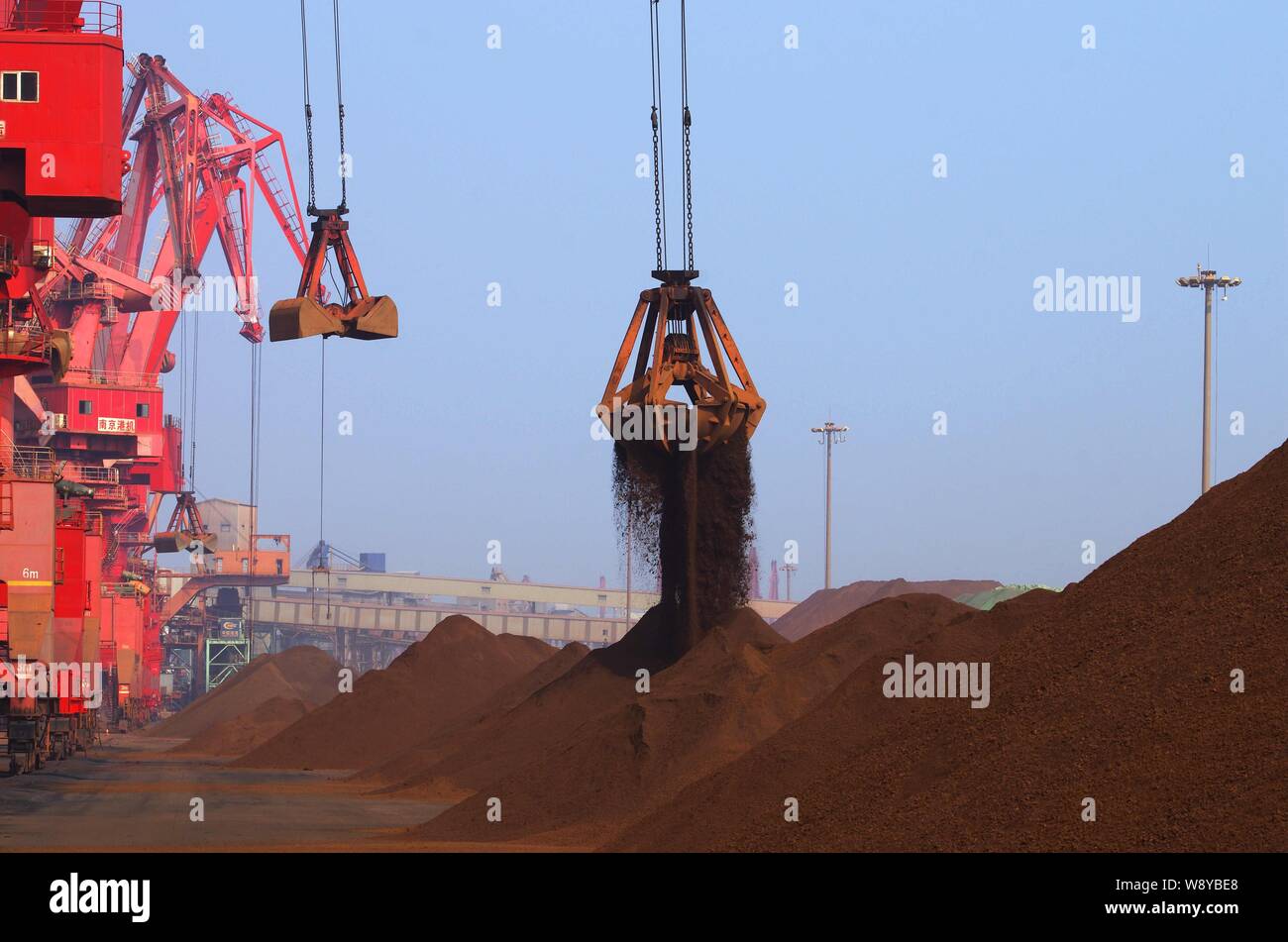 --FILE--Grab buckets unload iron ore on a quay at the Port of Rizhao in ...