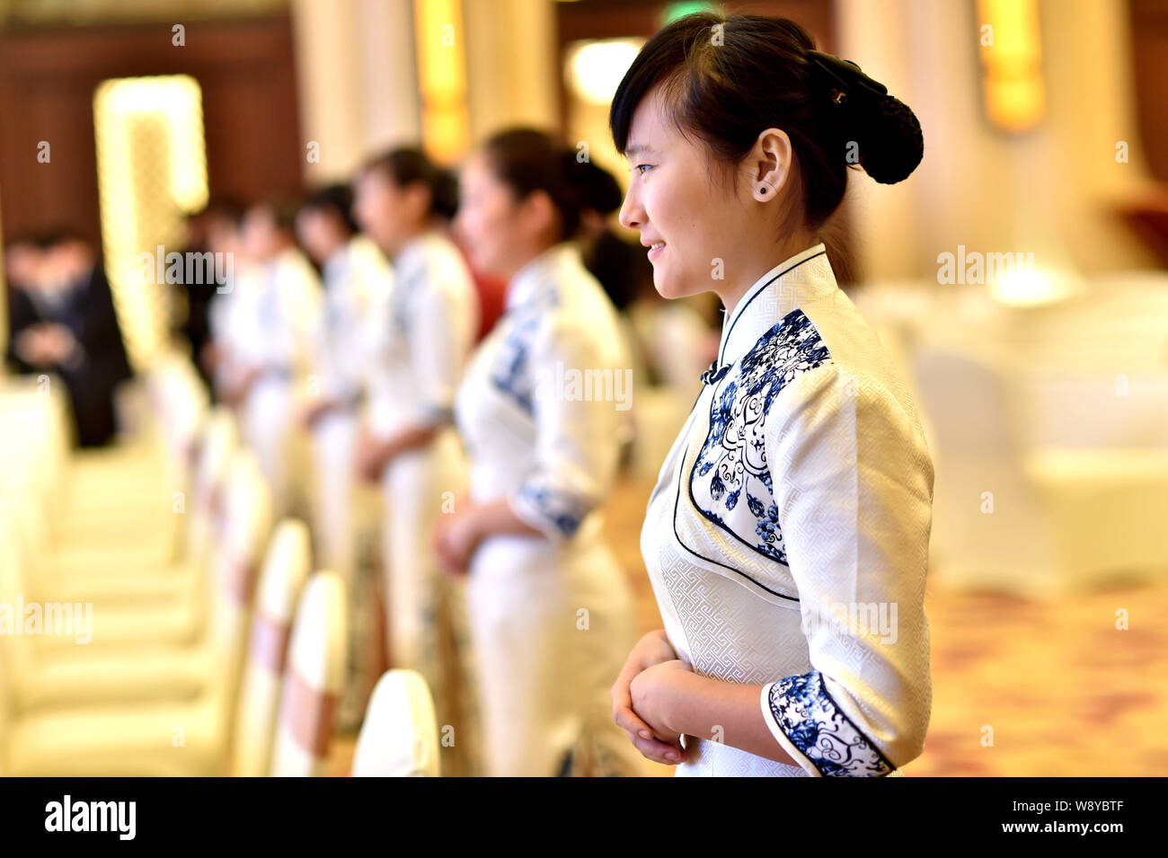 Chinese hostesses pose at a banquet hall ahead of the First World ...