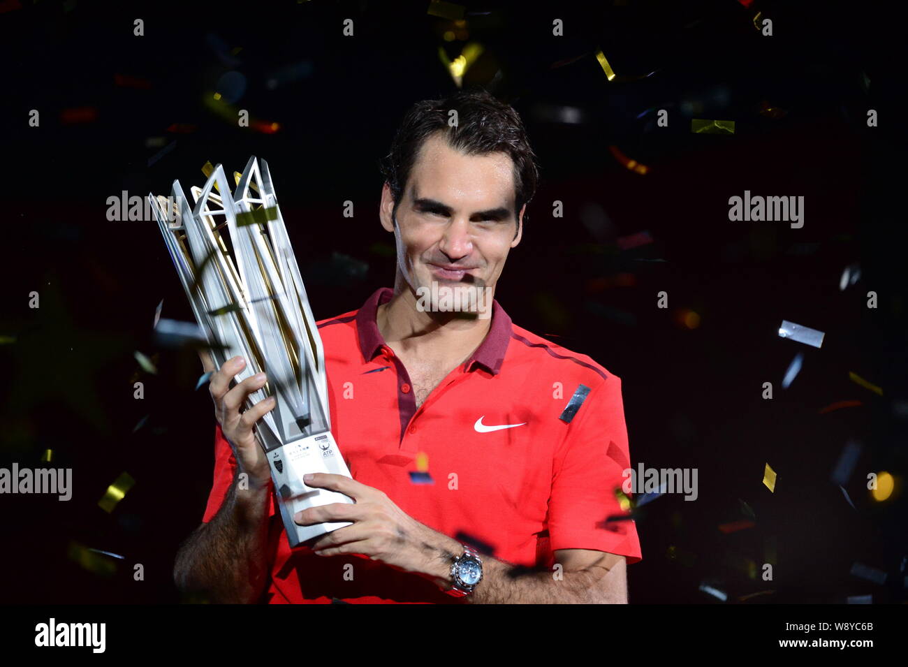 Roger Federer of Switzerland poses with his champion trophy at the ...