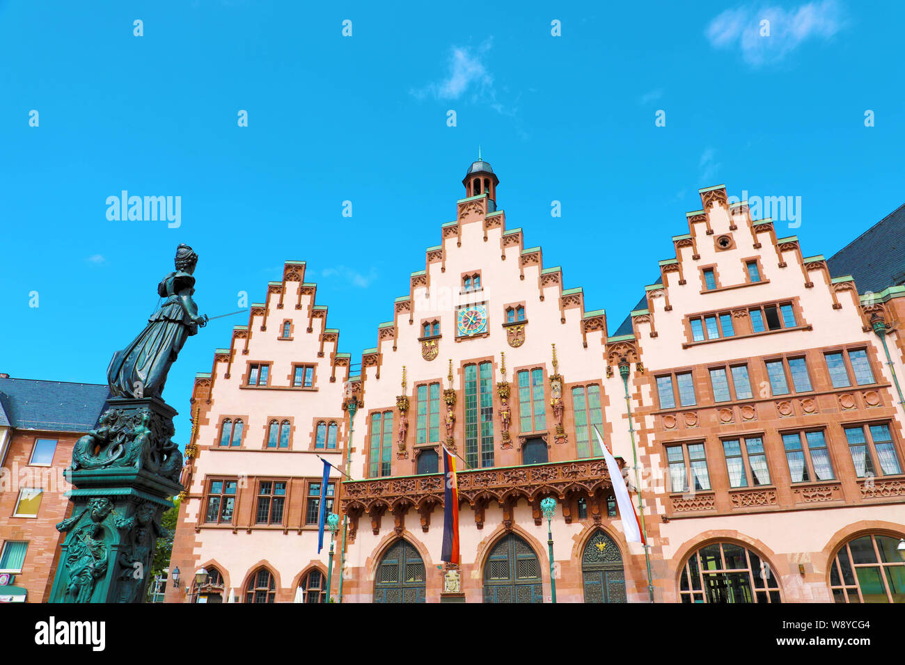 Romerberg square with the city hall and justice statue on blue sky ...
