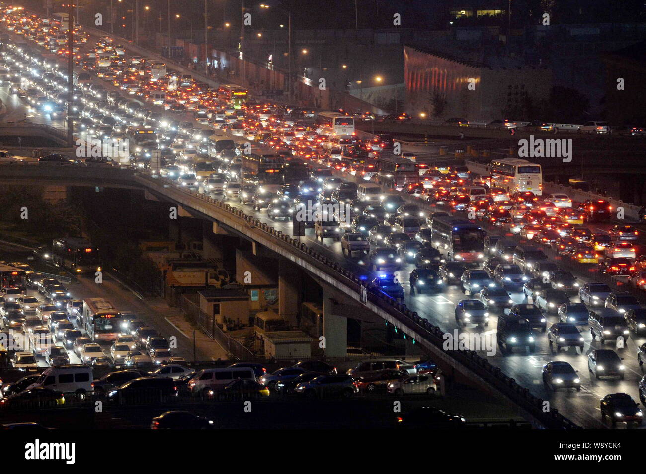 Night view of highways and roads overcrowded by masses of vehicles ...