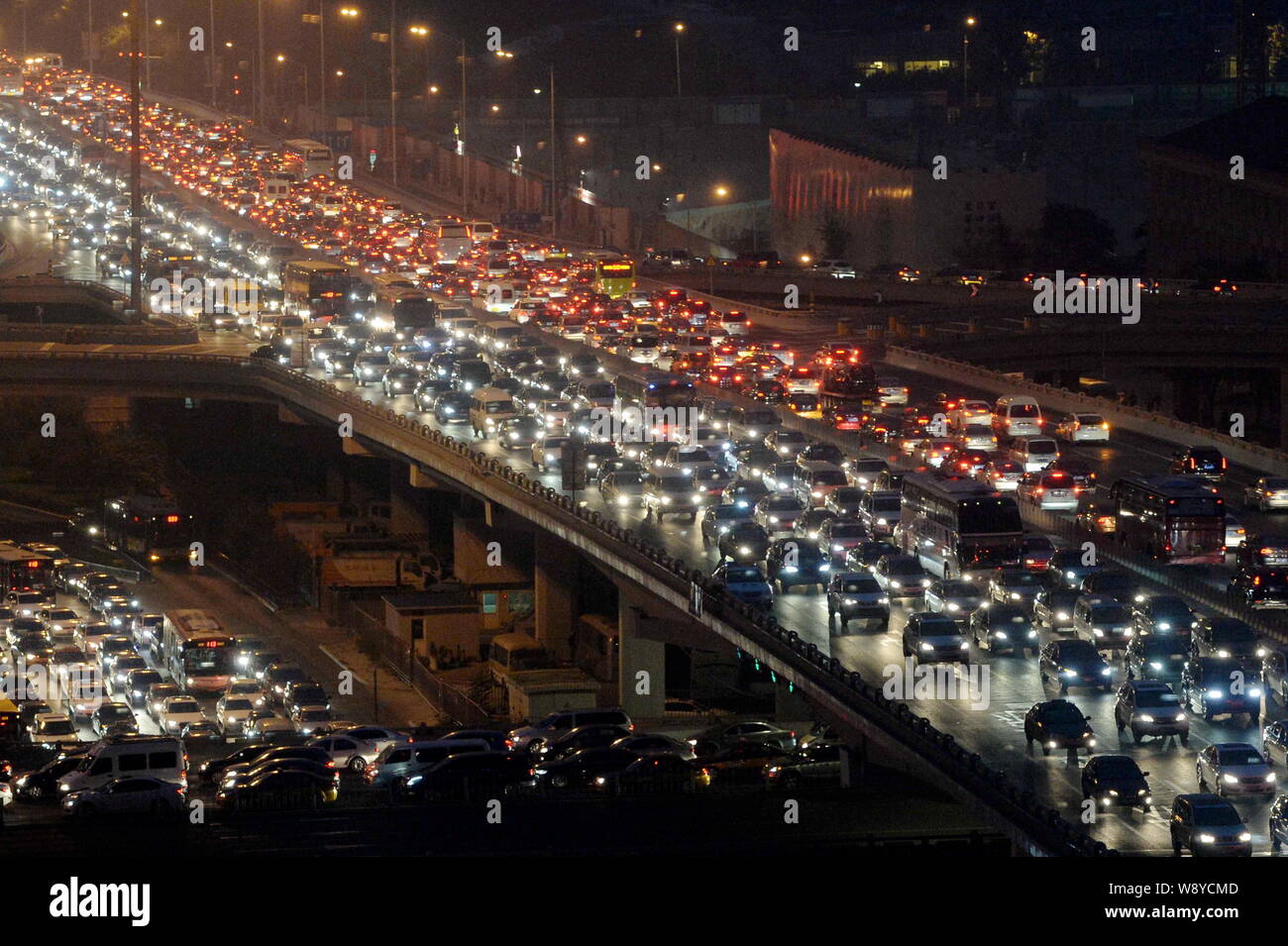 Night view of highways and roads overcrowded by masses of vehicles ...