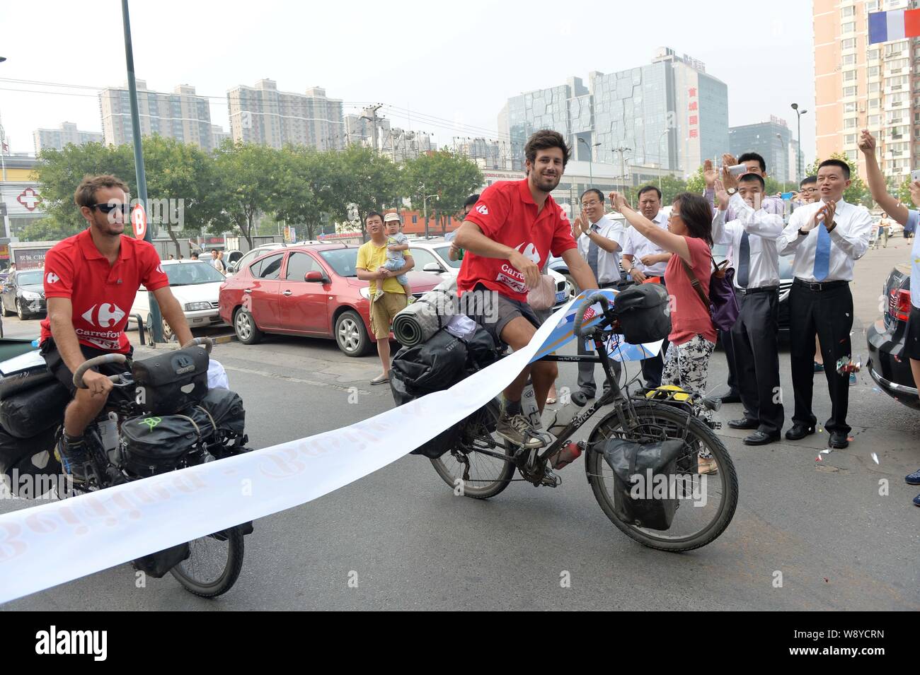 French cyclists Basile Pottier, left, and Simon Poniard, center, cross ...