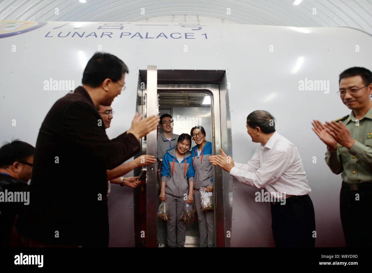 Officials welcome captain Xie Beizhen, back center, and her crew members Dong Chen, back left ...