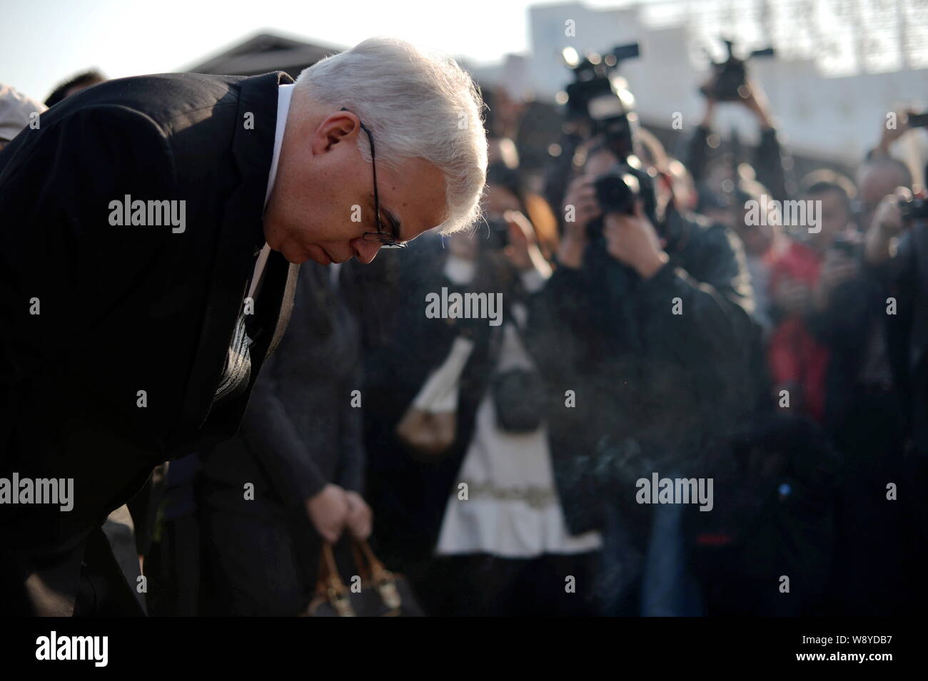 Peter Haymond, the United States consul general in Chengdu, bows to ...