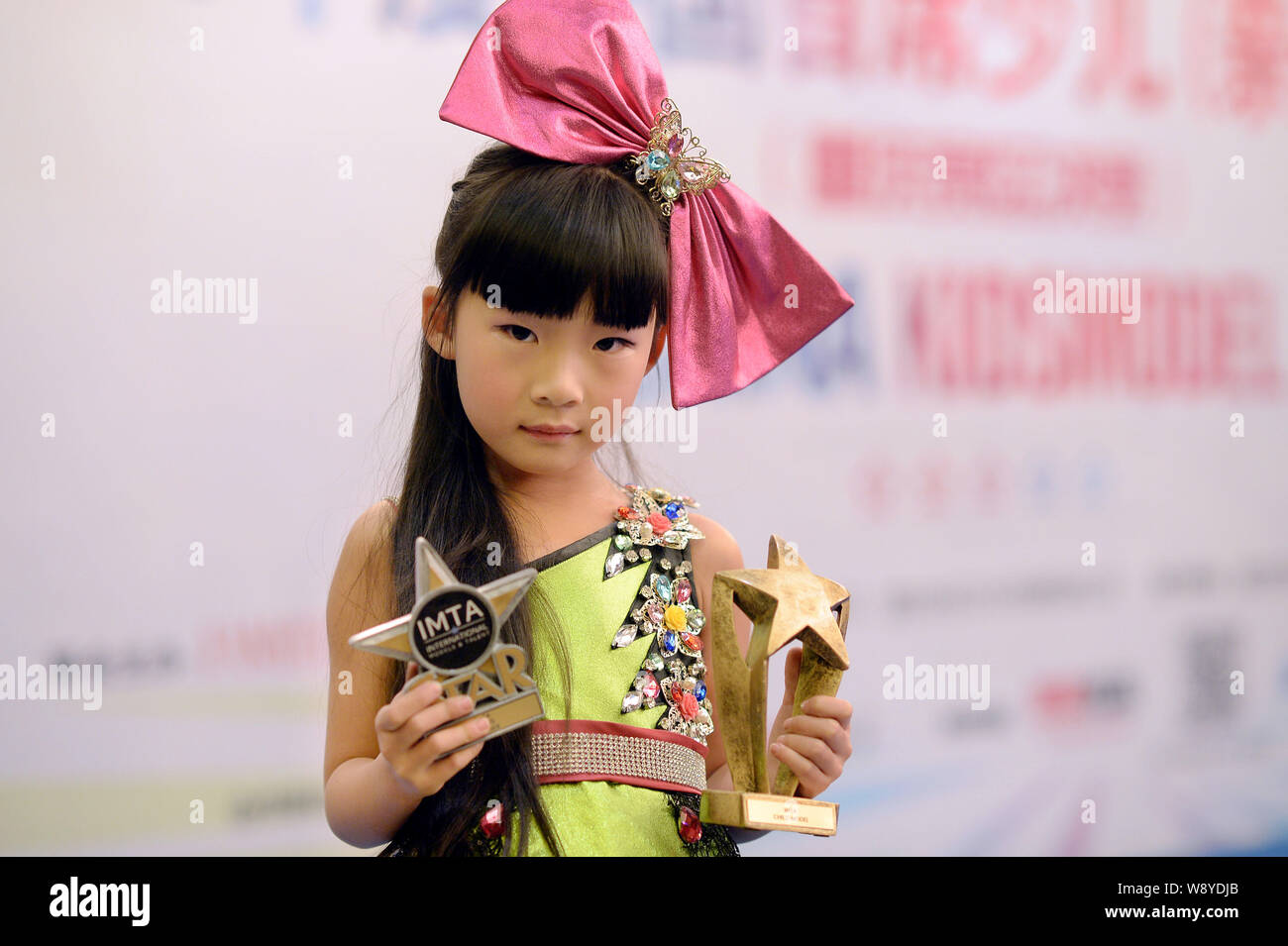 6-year-old Chinese child model Zhou Ziling poses with the trophies she ...