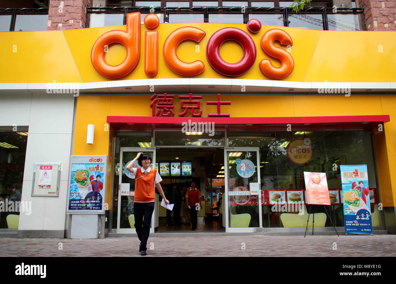 An employee leaves a Dicos fastfood restaurant in Chongqing, China, 8 ...