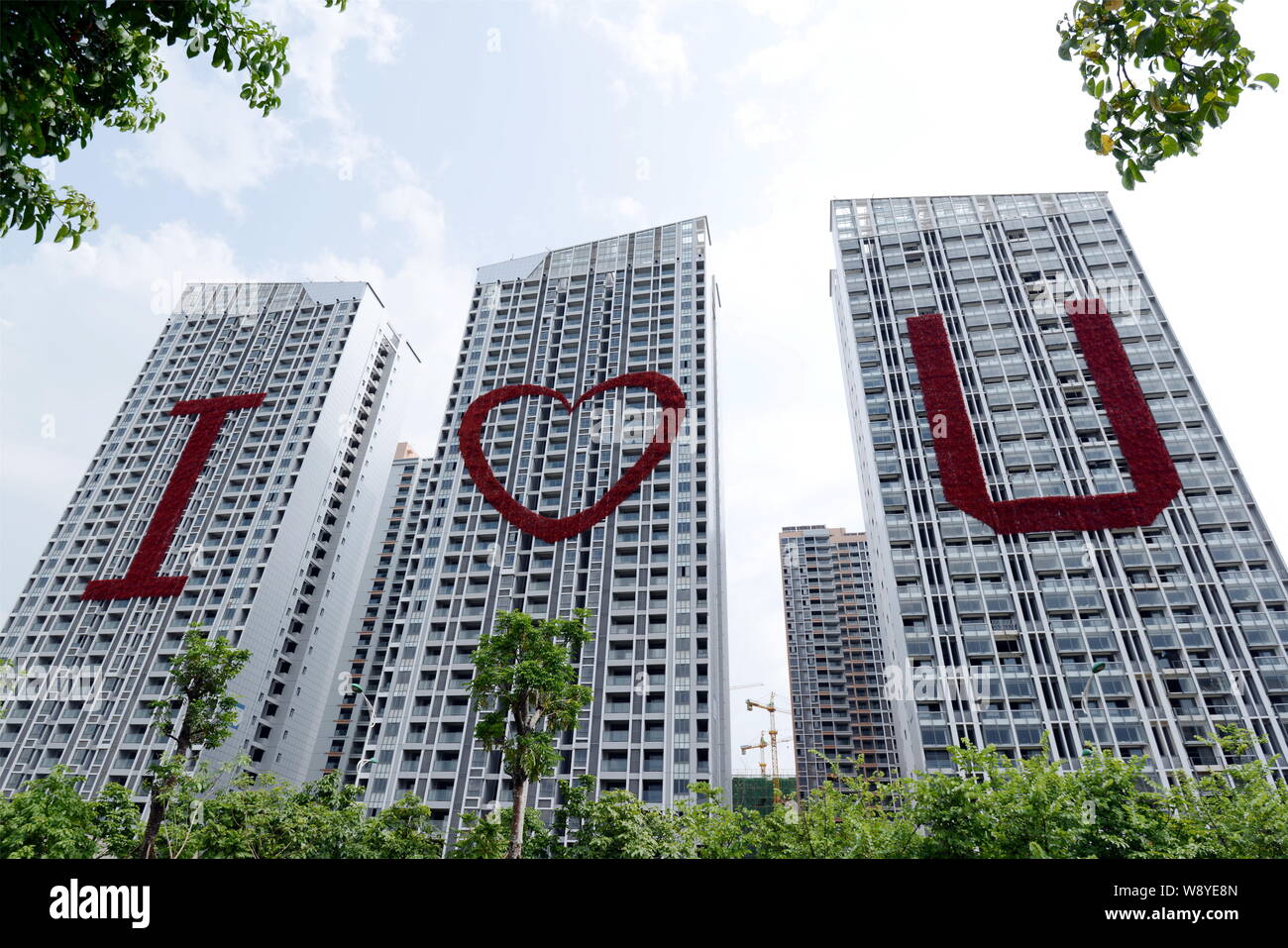 Three newly-constructed apartment buildings are decorated with about ...