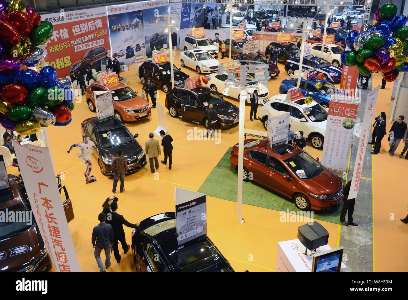 --FILE--Visitors look at cars of Honda, GAIC and Fiat at an auto show ...