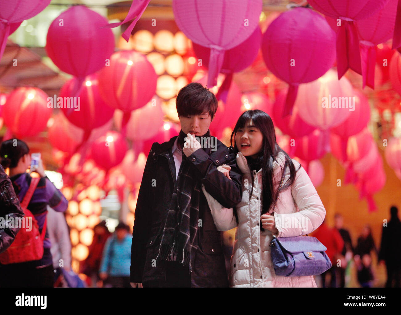 A couple enjoy lanterns on the eve of the Lantern Festival in Hong Kong ...