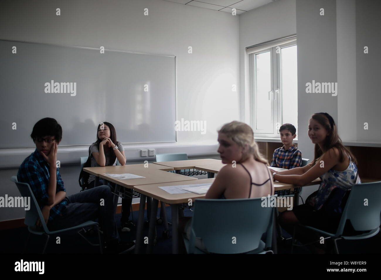 Foreign students sit in a classroom at the campus of Wellington College ...