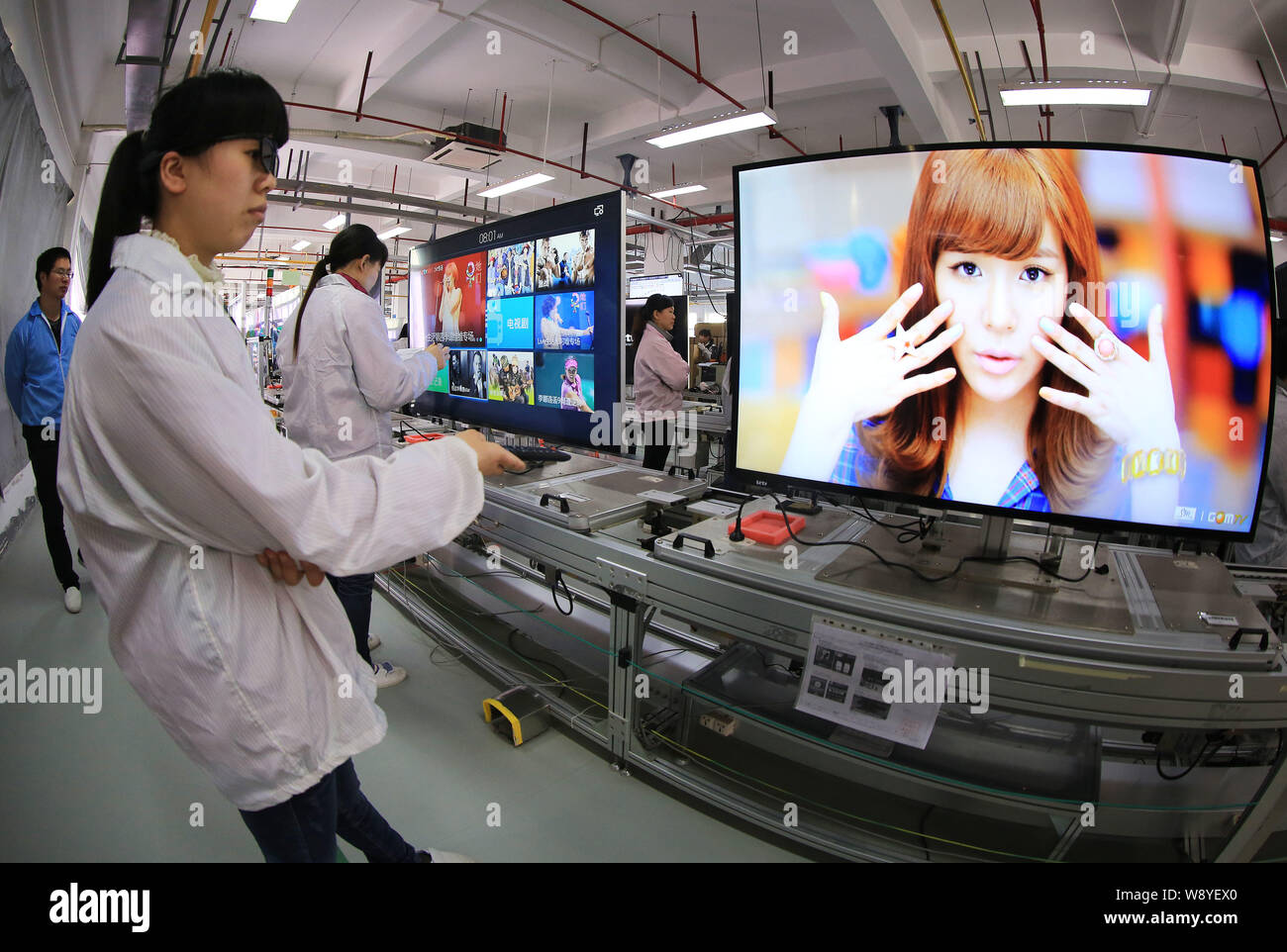 Female Chinese workers test smart TV sets of LeTV at the plant of Hong ... Female Chinese workers test smart TV sets of LeTV at the plant of Hong ...