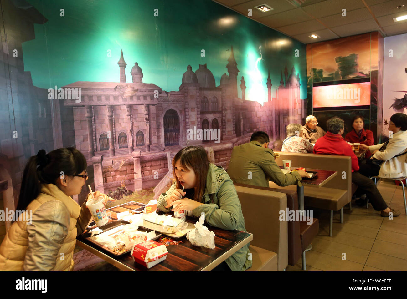 Customers eat food at a World-of-Warcraft-themed fast-food restaurant ...