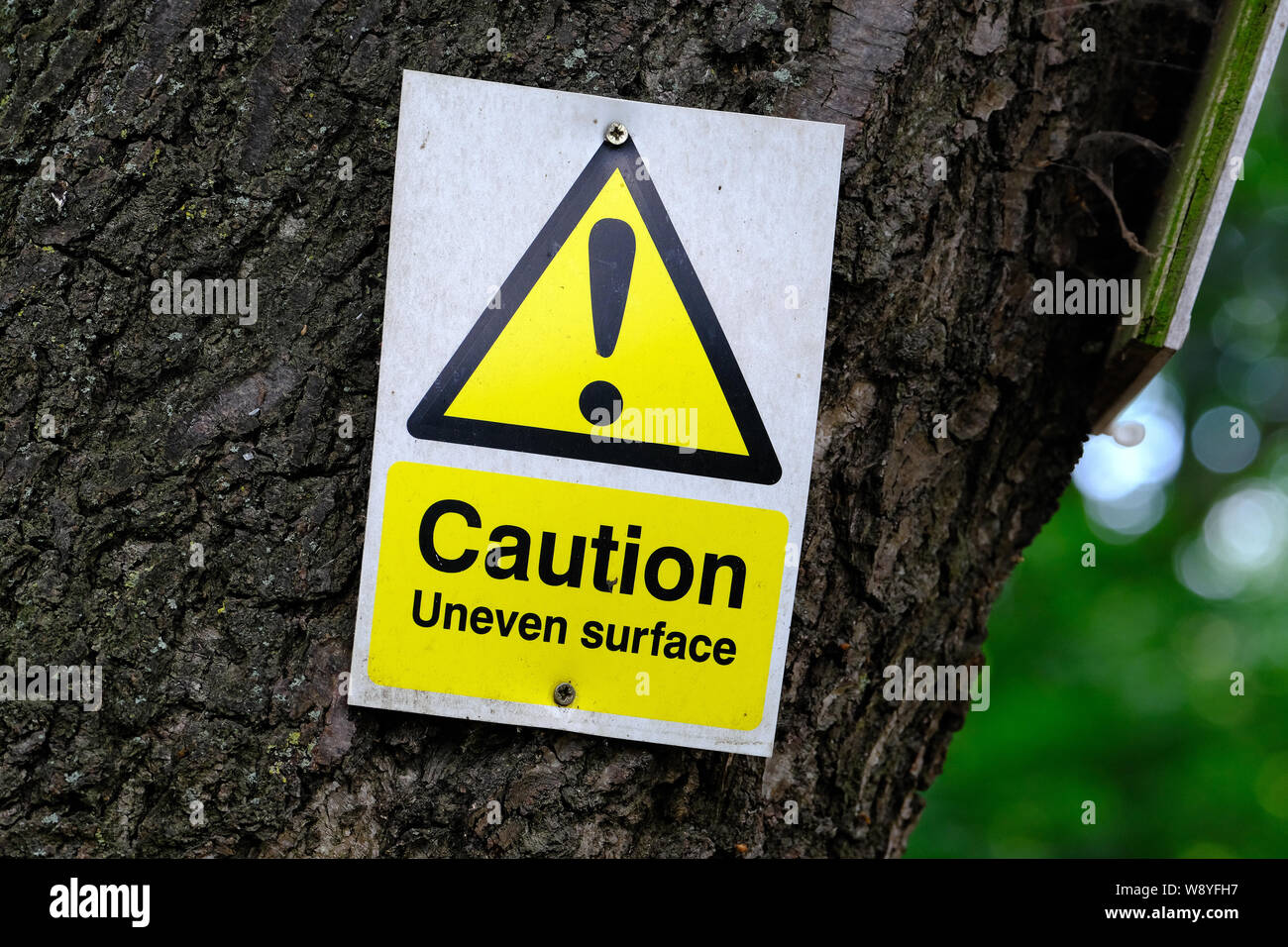 Caution sign for uneven walking surface Stock Photo - Alamy