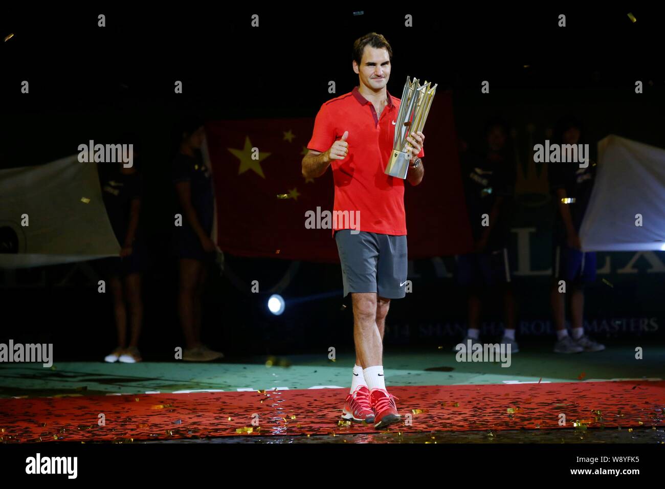 Roger Federer of Switzerland poses with his champion trophy at the ...