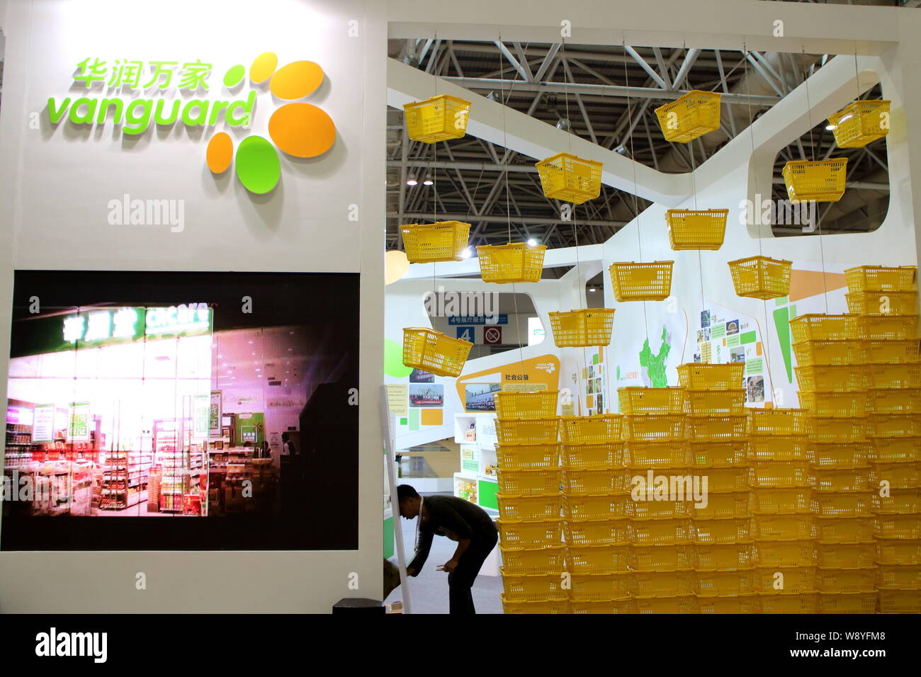 --FILE--An employee is seen at the stand of China Resources Vanguard, a ...