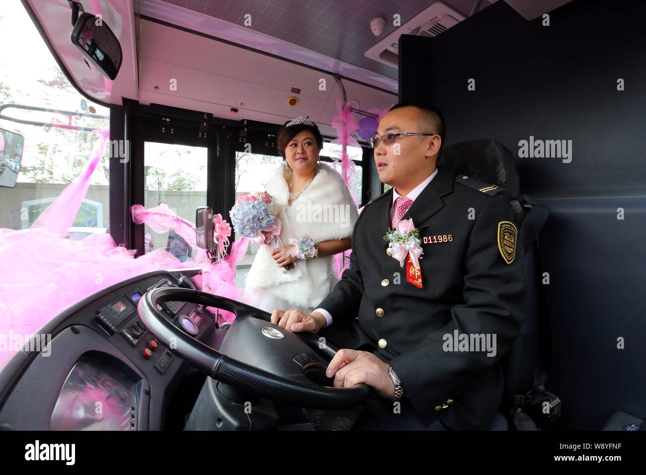 Chinese bus driver Lu Jia, right, drives a bendy bus as a wedding ...