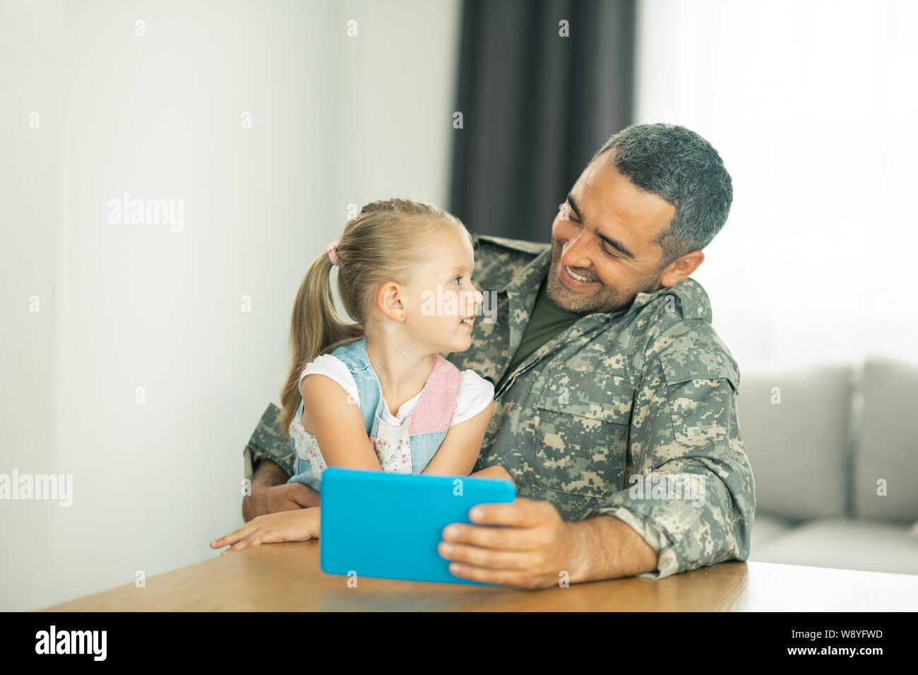 Girl talking to daddy coming back home after military service Stock ...