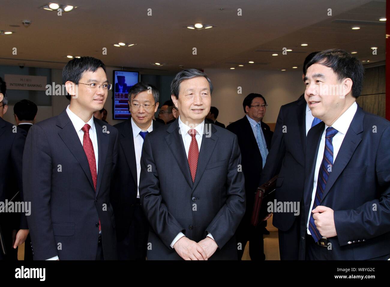 Chinese Vice Premier Ma Kai, front center, visits a branch of Bank of ...