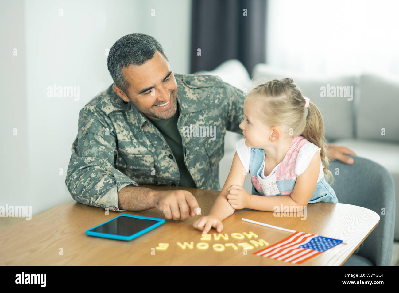 Handsome military officer smiling to his lovely daughter Stock Photo ...
