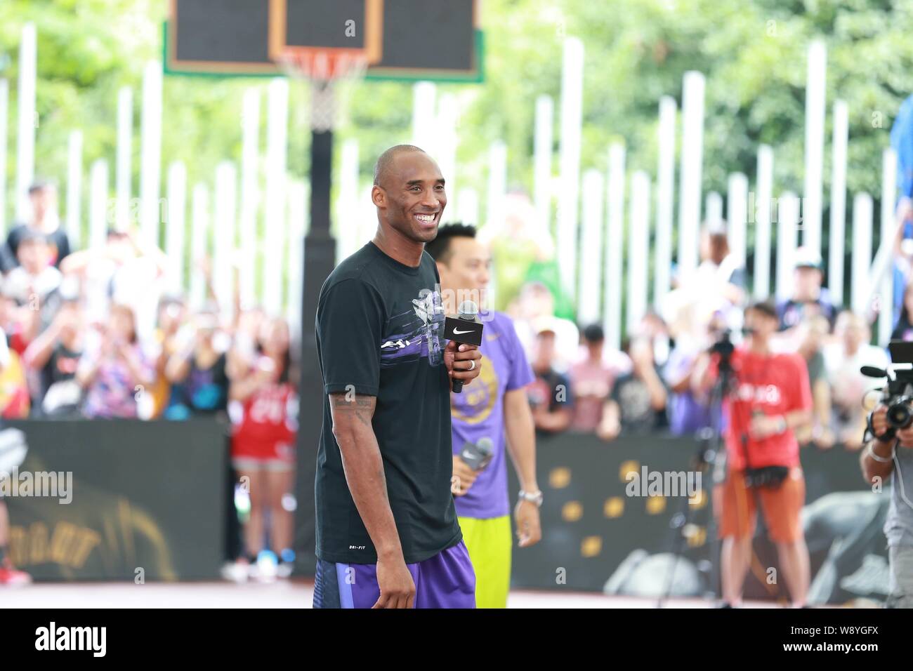 NBA superstar Kobe Bryant, front, smiles at a fan meeting during his ...