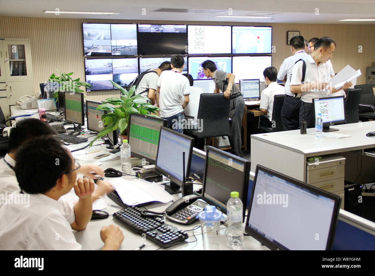 --FILE--Chinese employees work in the command center at the Wuhan ...