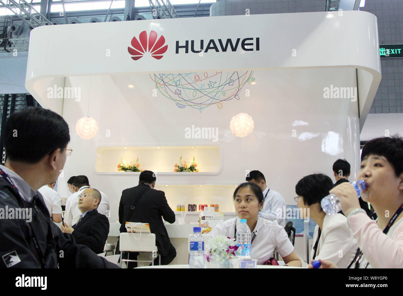 --FILE--Visitors sit at the stand of Huawei during the 3rd Mobile Asia ...