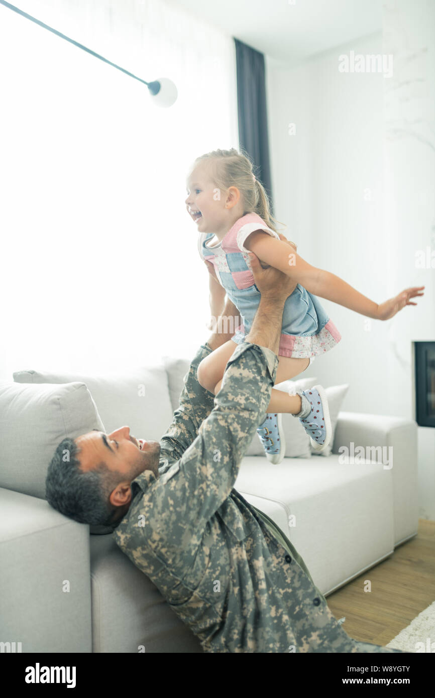 Man coming back home after military service playing with daughter Stock ...