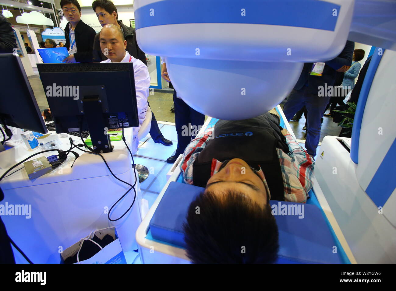 A visitor, right, takes a stomach check by using the capsule robot ...